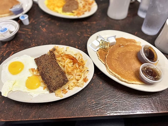 The classic American breakfast trinity—eggs, meat, and pancakes—executed with the confidence that comes from decades of practice.