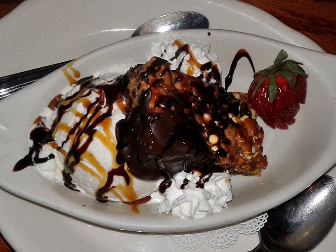 Dessert that doesn't know the meaning of restraint—warm brownie, cool ice cream, and sauces that zigzag with reckless, delicious abandon.