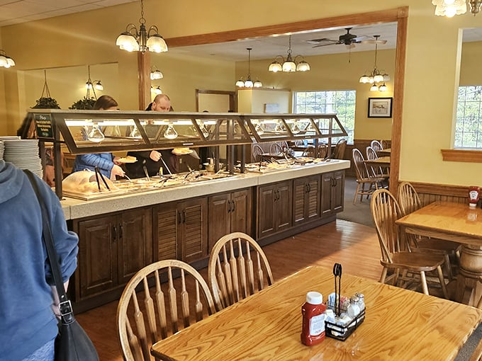The buffet line—a wooden-cabinet masterpiece housing treasures more valuable than any pirate could imagine: homestyle cooking ready for the taking.