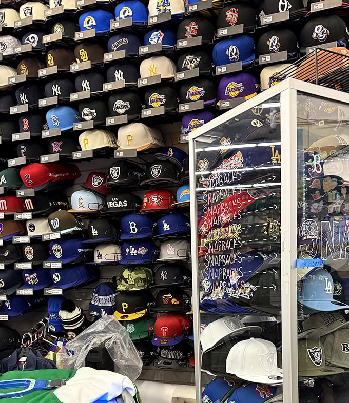 Sports loyalty on display! This wall of team caps could settle—or start—a thousand rivalries. The Lakers purple and gold naturally commands prime real estate.