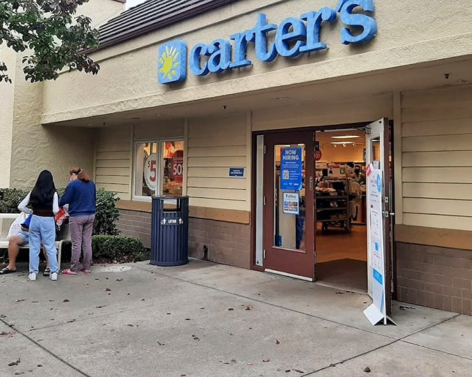 Carter's storefront welcomes tiny fashion plates and their budget-conscious parents with bright signage and the promise of adorable outfits at outlet prices.