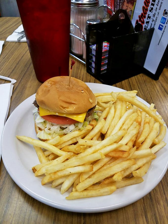 A burger that doesn't need Instagram filters or fancy aioli—just honest ingredients stacked between a soft bun with fries that actually taste like potatoes.