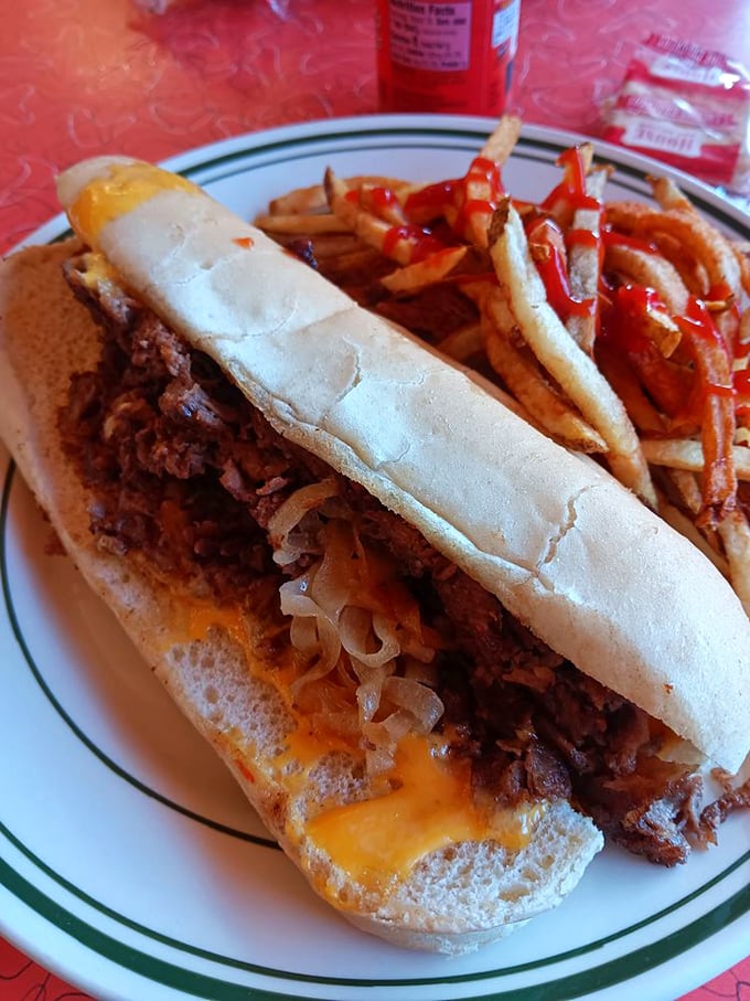 The cheesesteak sandwich stretches gloriously across the plate, with melted cheese and tender beef in perfect harmony—a Pennsylvania classic with Ohio hospitality.