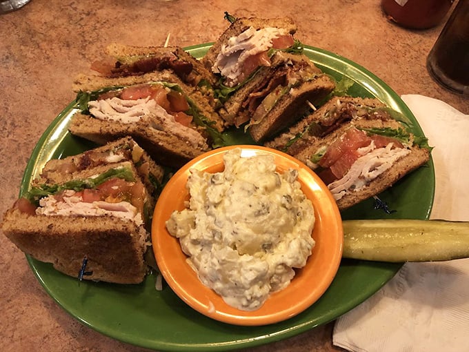 The club sandwich – architecture you can eat, layered with care and served with potato salad that didn't come from a plastic tub at the supermarket.