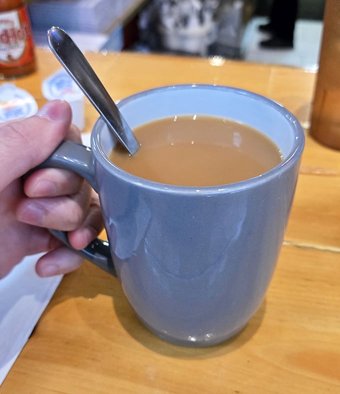 That perfect shade of coffee that promises to transform you from zombie to functioning human—liquid optimism in ceramic form.