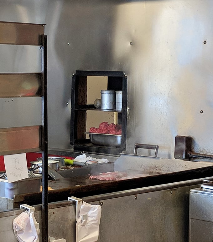 The well-seasoned grill where the magic happens—no fancy kitchen equipment, just decades of burger-making wisdom baked into every square inch.