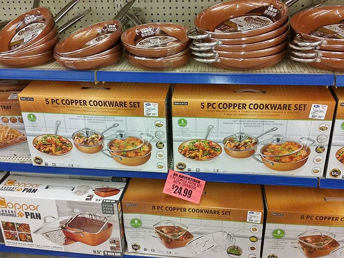 Copper cookware sets gleam under fluorescent lights, promising gourmet possibilities without the Williams-Sonoma price tag—culinary dreams within reach.