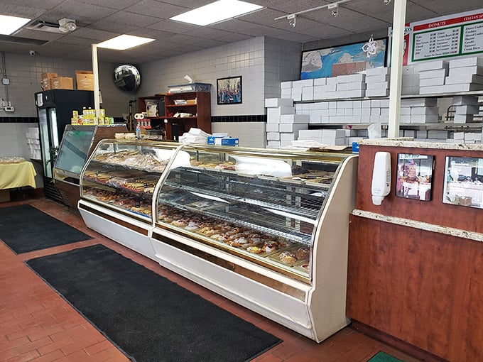 The display case at Auddino's isn't just filled with pastries – it's filled with reasons to abandon your diet and embrace the sweet life.