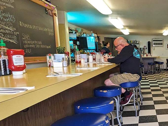 Behind this counter, skilled hands craft culinary magic while maintaining the ancient art of diner conversation.