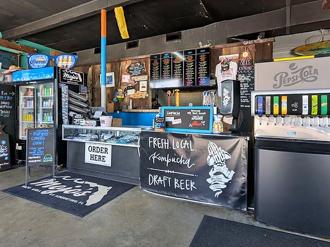The ordering counter—where dreams become reality. Note the kombucha and draft beer signs, because tacos deserve proper liquid companionship.