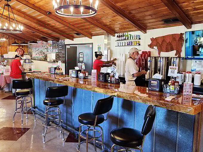 The counter where barbecue dreams come true. Notice the pig silhouette watching approvingly from the wall—the patron saint of pork.