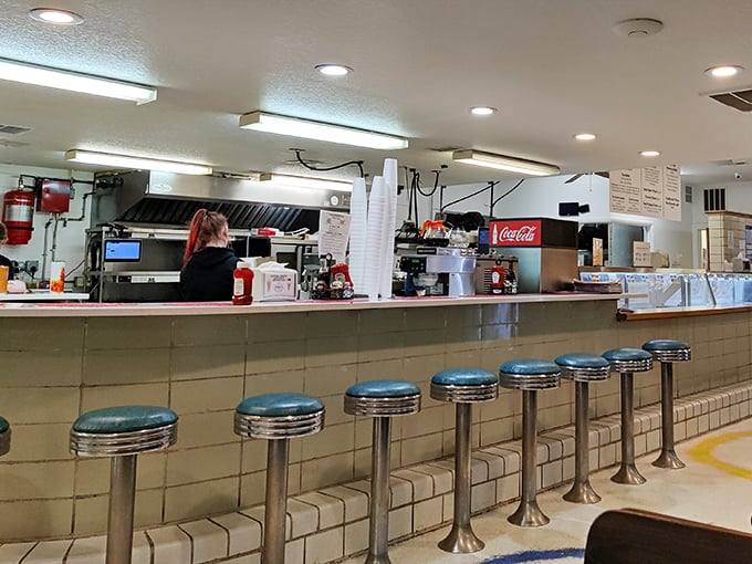 Classic counter seating—where solo diners become food critics and the best local gossip is served alongside your coffee. 