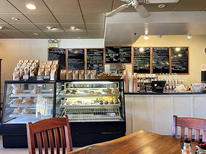 The display case—a glass-fronted museum of pastry possibilities. Morning decisions have never been so deliciously complicated.