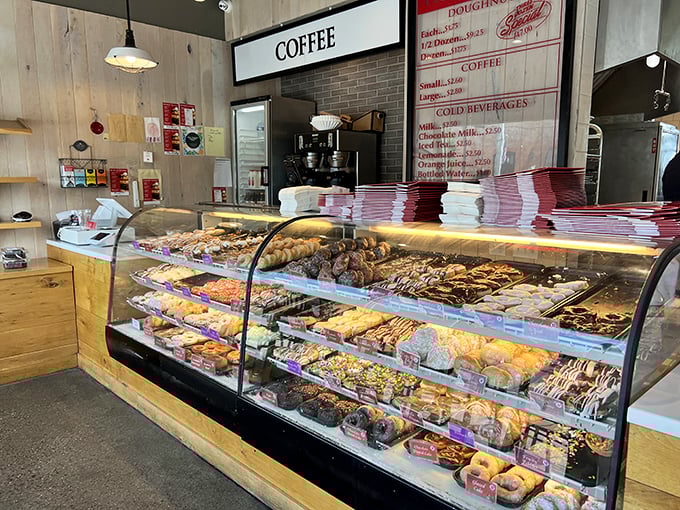The display case—a museum of edible art where each shelf tells a different story of sugar, spice, and everything worth the calories.