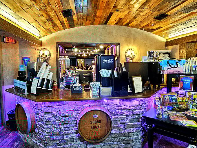 The bar area combines rustic charm with modern flair—wooden barrels meet purple lighting in a space that says, "Yes, we take our drinks as seriously as our giant meatball sculpture."
