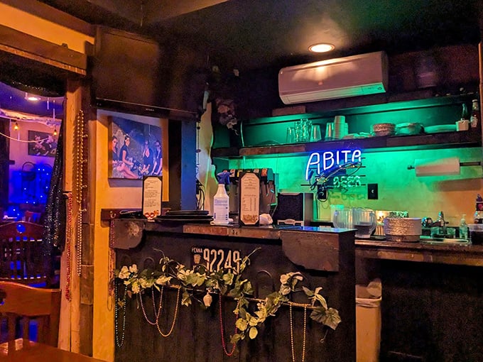 The bar area glows with Mardi Gras spirit year-round. Those beads aren't just decoration—they're a promise of the celebration happening on your plate.