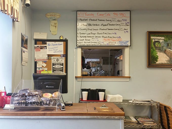 The order counter—where dreams are placed and magic begins. That whiteboard menu is a roadmap to satisfaction.