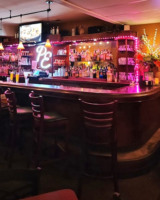The bar glows with neon promise, like a beacon saying "Yes, that cocktail you're craving is exactly what you deserve after a long day."