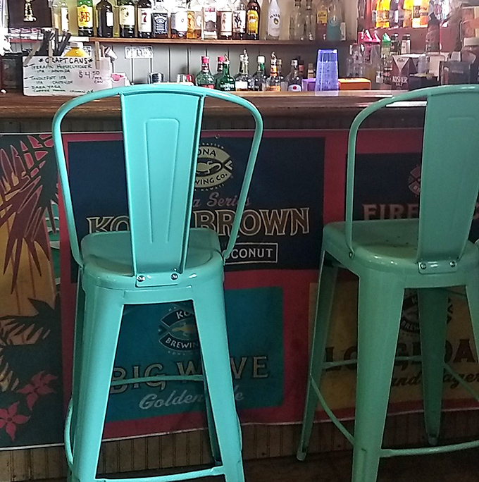 Turquoise metal chairs add a pop of coastal color to the bar area, inviting you to pull up a seat and stay awhile.