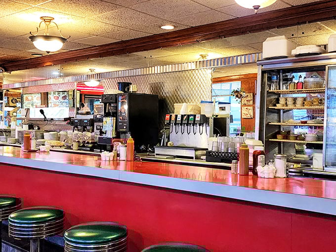 The counter—where solo diners find community, regulars exchange neighborhood news, and everyone gets a front-row seat to the breakfast ballet.