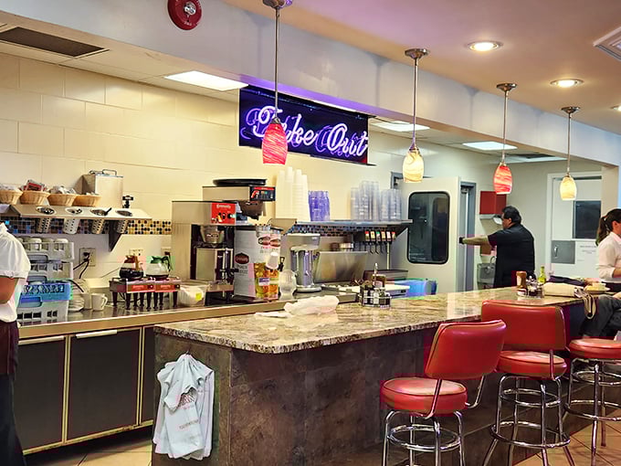 The counter offers front-row seats to the culinary concert—where coffee flows and short-order magic happens.