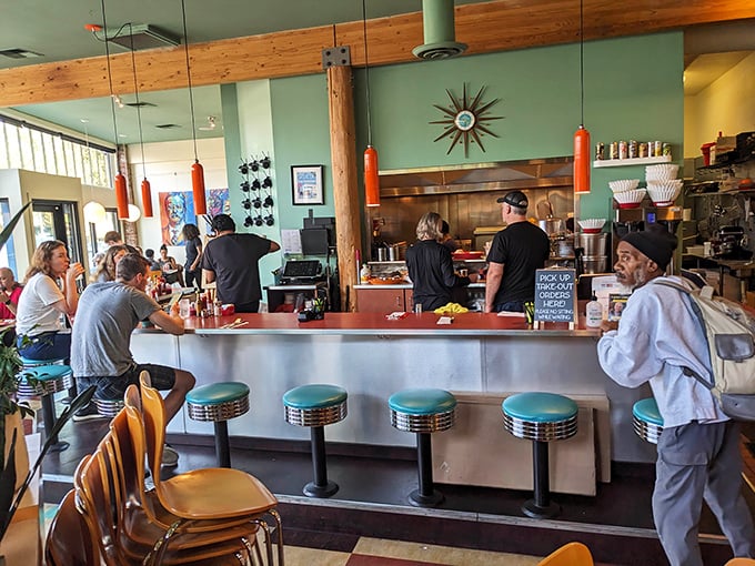 The counter seats aren't just spots to eat—they're front-row tickets to the breakfast theater, complete with turquoise vinyl and stainless trim.