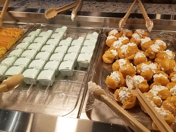 Mint-green puddings neighbor cream puffs topped with whipped cream—proof that at Waha, the sweet finale gets the same attention as the main event.