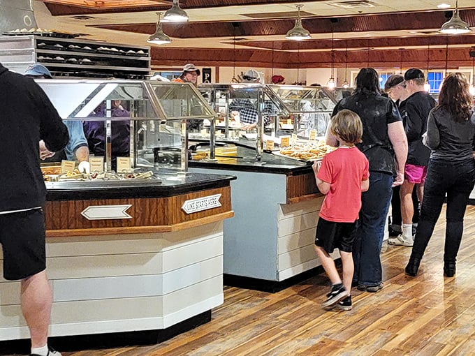 Families line up with the universal look of buffet anticipation—that gleeful "I'm about to try everything" expression that crosses all age boundaries.