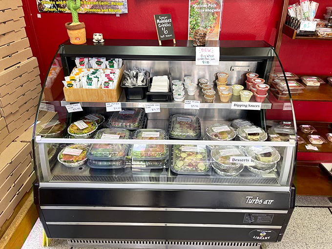 The deli case – where decisions get harder and willpower goes to die. Each container holds a different delicious destiny.