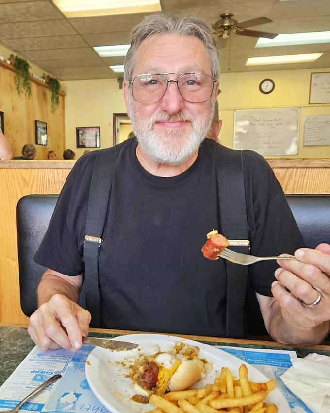 A patron enjoying his meal with the kind of satisfaction that no five-star restaurant review can adequately capture. This is food that makes you smile.