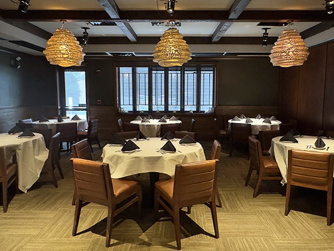 White tablecloths and distinctive pendant lighting create dining spaces that feel both intimate and spacious—like your fancy living room, if you actually used it.