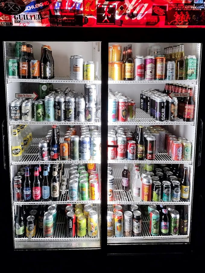The beer fridge at Calamari's doesn't just offer options—it presents a colorful gallery of liquid possibilities from craft to classic.