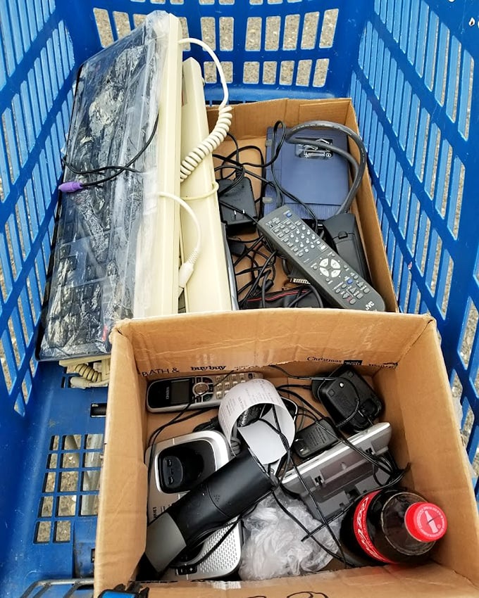 Technology time capsules nestled in blue plastic—yesterday's gadgets waiting for tomorrow's tinkerers and nostalgic collectors.
