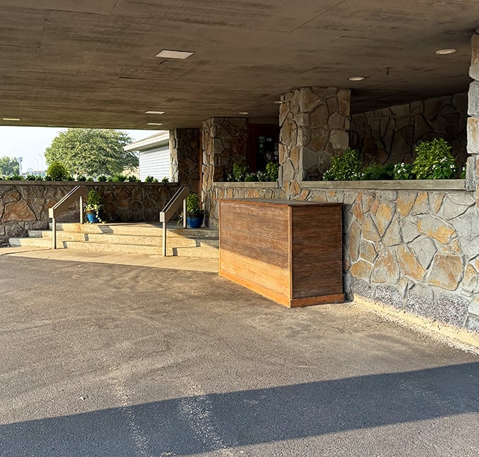 The entrance welcomes you like an old friend – stone pillars standing guard over decades of dining memories and celebrations.