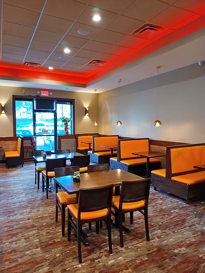 Red ceiling accents and modern lighting create the perfect backdrop for the important decision-making of "second plate or straight to dessert?"