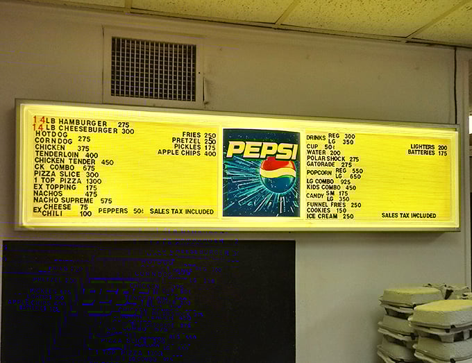 The illuminated menu board—a beacon of movie night sustenance. Decisions, decisions: nachos supreme or the classic cheeseburger combo?