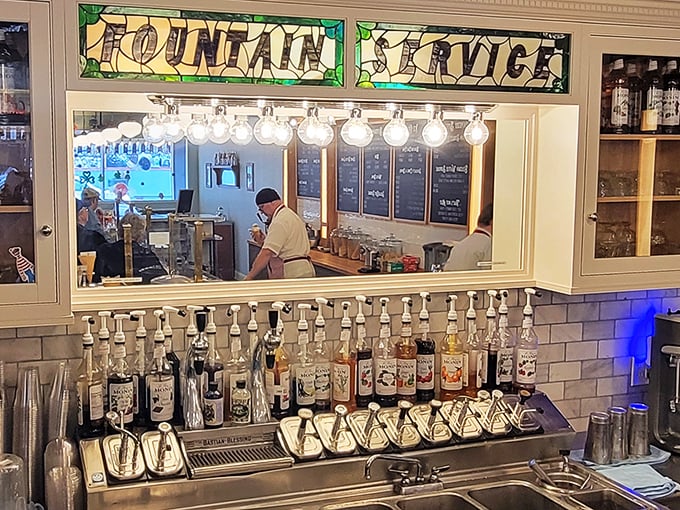 That stained glass "Fountain Service" sign isn't just decoration—it's a promise of fizzy, frothy delights crafted with the precision of a Swiss watchmaker.