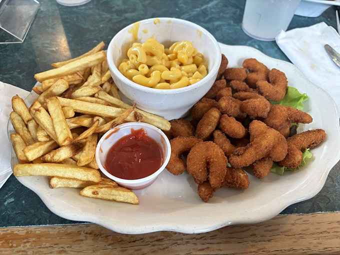 Golden-fried shrimp, crispy fries, and mac and cheese – the holy trinity of comfort food that makes you feel like a kid with a grown-up's appetite.
