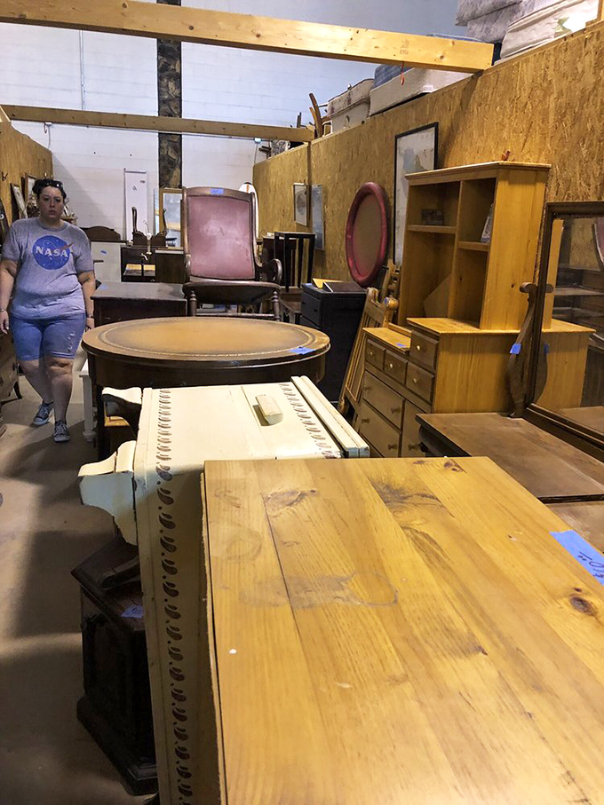 Vintage furniture waits patiently for its second act, each wooden dresser and table holding stories of past homes while awaiting new adventures.