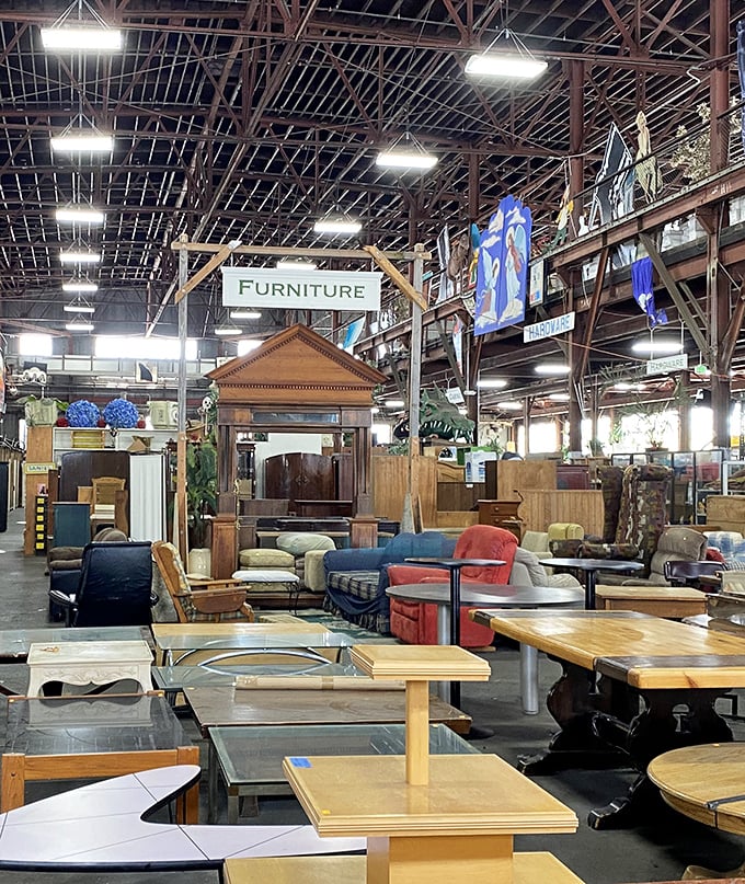 The furniture section stretches beneath industrial rafters, a showroom where mid-century meets Victorian meets "what exactly is that style?"