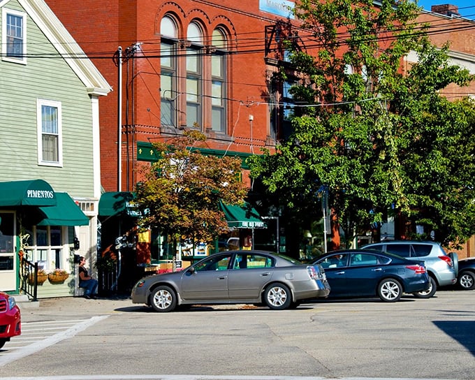 Historic buildings in varying hues create Exeter's distinctive streetscape, where green awnings invite shoppers into establishments that have served generations.