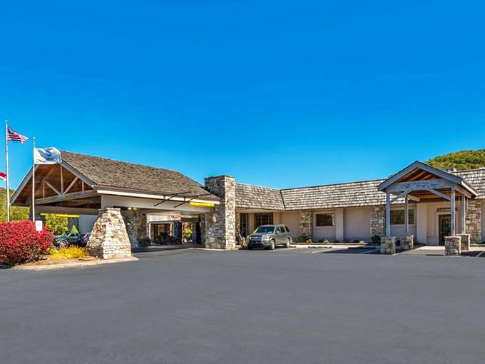 This mountain lodge entrance says "welcome" with stone pillars and timber beams—architecture that speaks the universal language of "come in and relax."