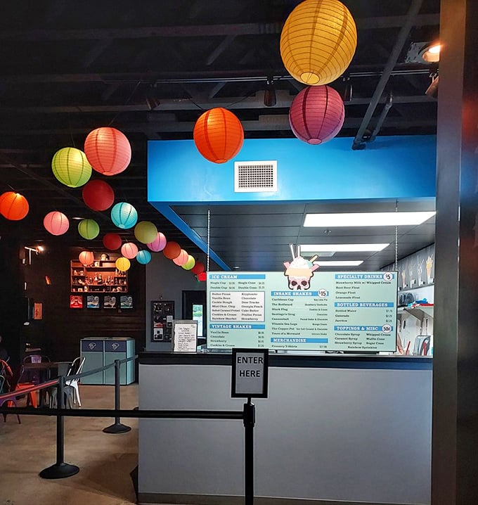 The ordering counter—where life-changing decisions are made daily under the watchful gaze of a skull wearing a chef's hat.