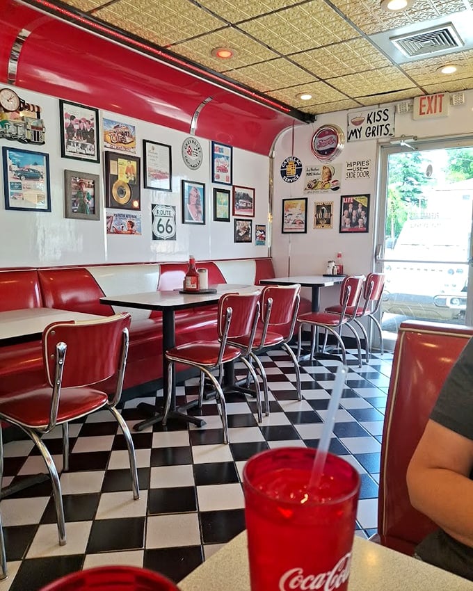 Red booths, Route 66 signs, and that "Kiss My Grits" wall art—this isn't decoration, it's a love letter to American diner culture.