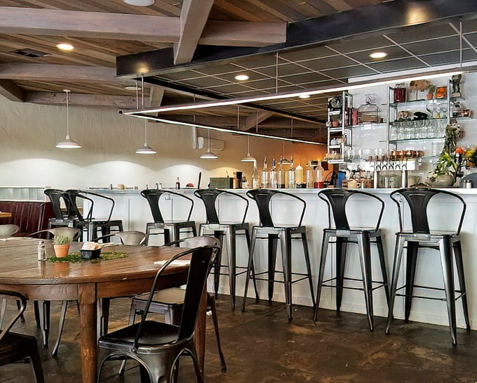 Industrial meets cozy at the sleek bar area. Metal stools invite solo diners to perch and ponder life's important questions, like "pancakes or waffles?"