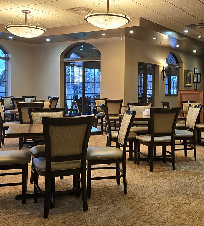 Elegant pendant lighting casts a warm glow over comfortable seating—this isn't fast food, it's a dining experience worth savoring.