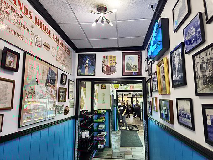 The hallway of fame—where vintage signs and local memorabilia create the perfect appetizer before your meal arrives.