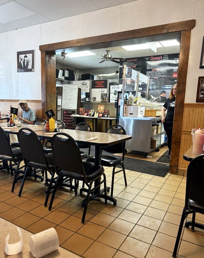 The kitchen pass-through offers a glimpse of sandwich artistry in action—like watching Picasso, but with meat.