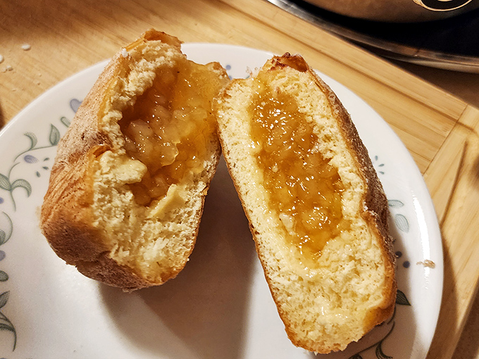 The cross-section reveals the treasure within—a perfect ratio of pillowy dough to sweet, tangy filling.