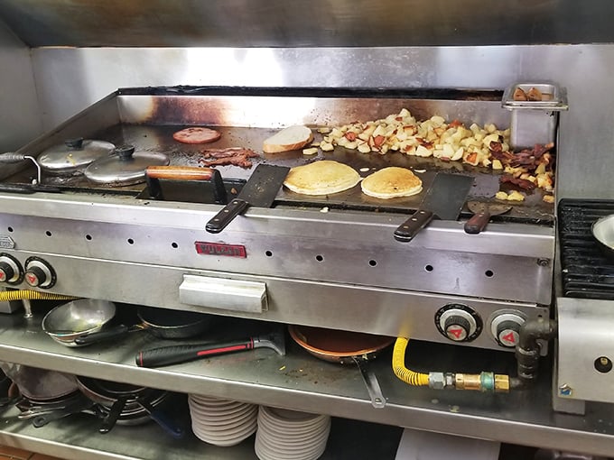 The griddle ballet in action – where pancakes, potatoes, and perfection dance together in cast-iron choreography.